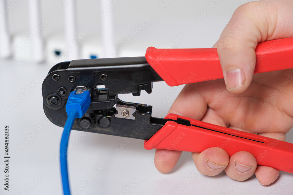 The computer master crimps the connection of the Vlan connector with a ...