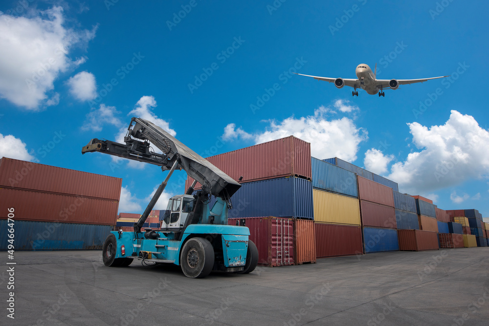 Cargo planes flying over container trucks and forklifts are used for ...