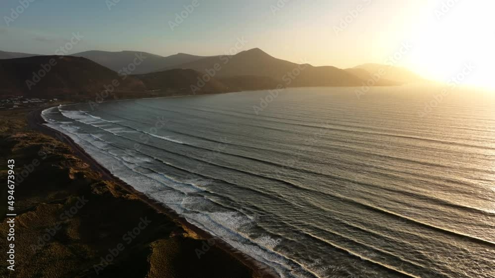 Rossbeigh Beach, Kerry, Ireland, March 2022. Drone slowly orbits the ...