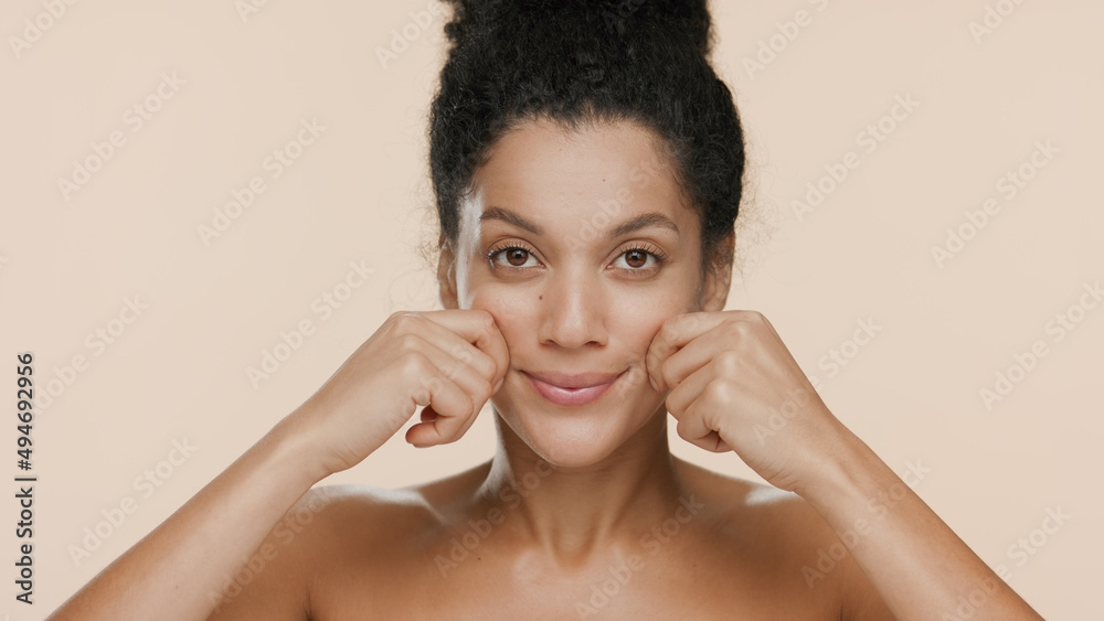 Beautiful African American young slim woman stretches her skin on ...