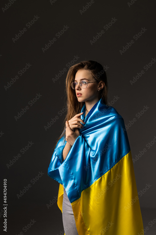 Ukrainian Woman Holds Ukrainian Blue And Yellow Flag On Black ukrainian-woman-holds-ukrainian-blue-and-yellow-flag-on-black