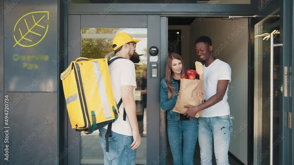 Smart food delivery service, man handing out fresh food to recipient ...