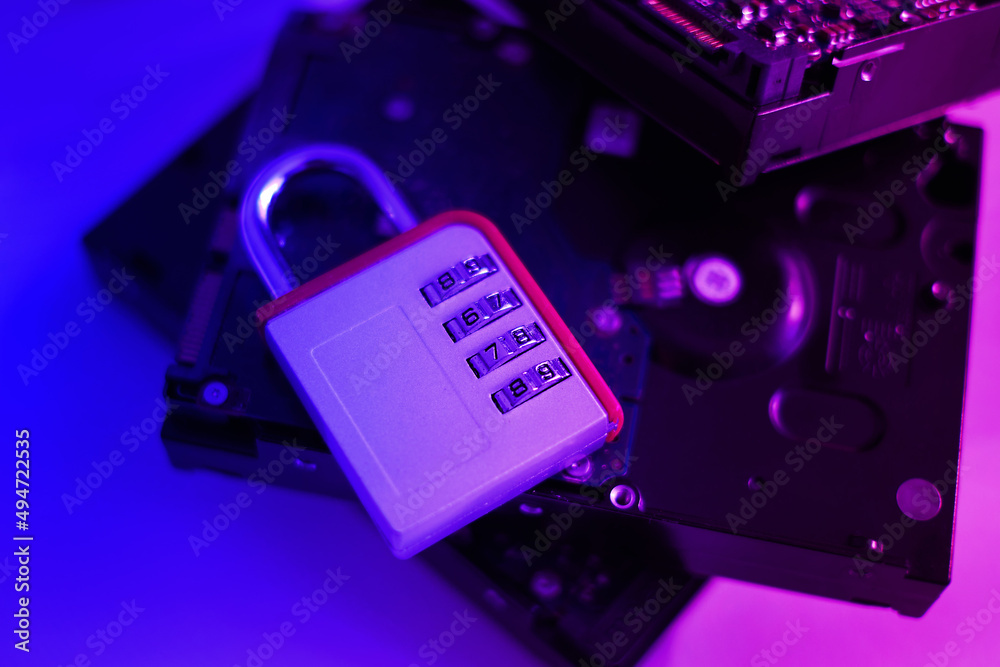 Encrypted hard disk. Padlock with cipher on an opened hard disk. Data ...
