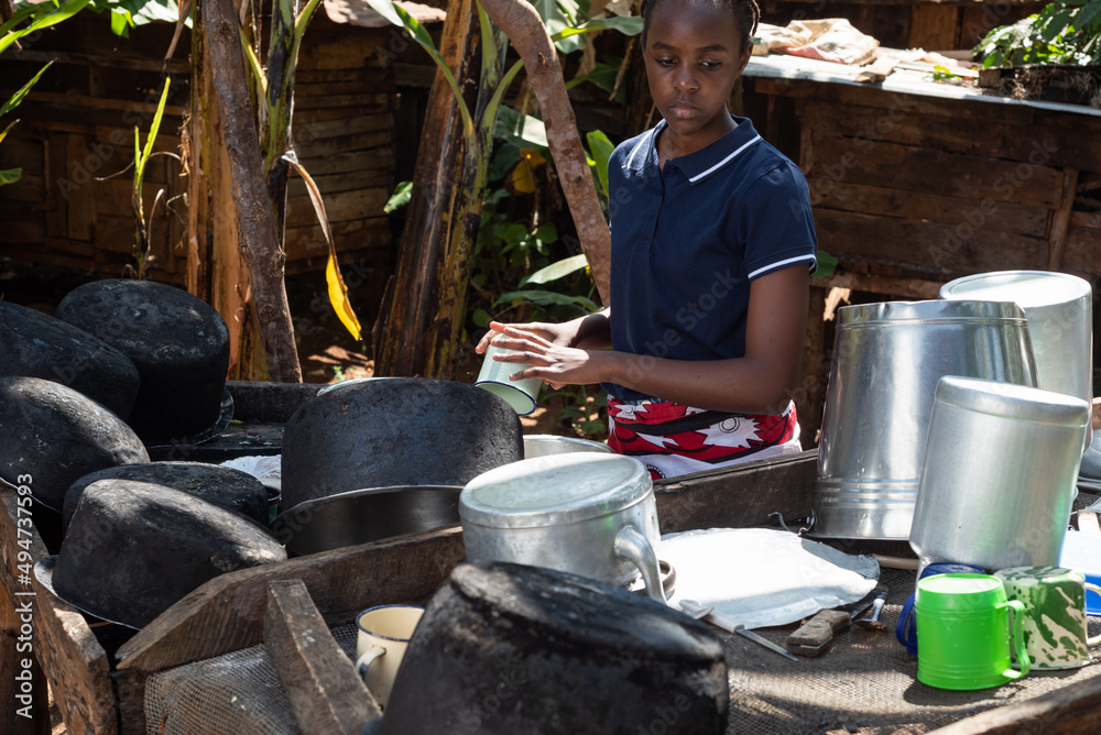 Young Teenage African Girl washing dishes at and outdoor area Stock ...