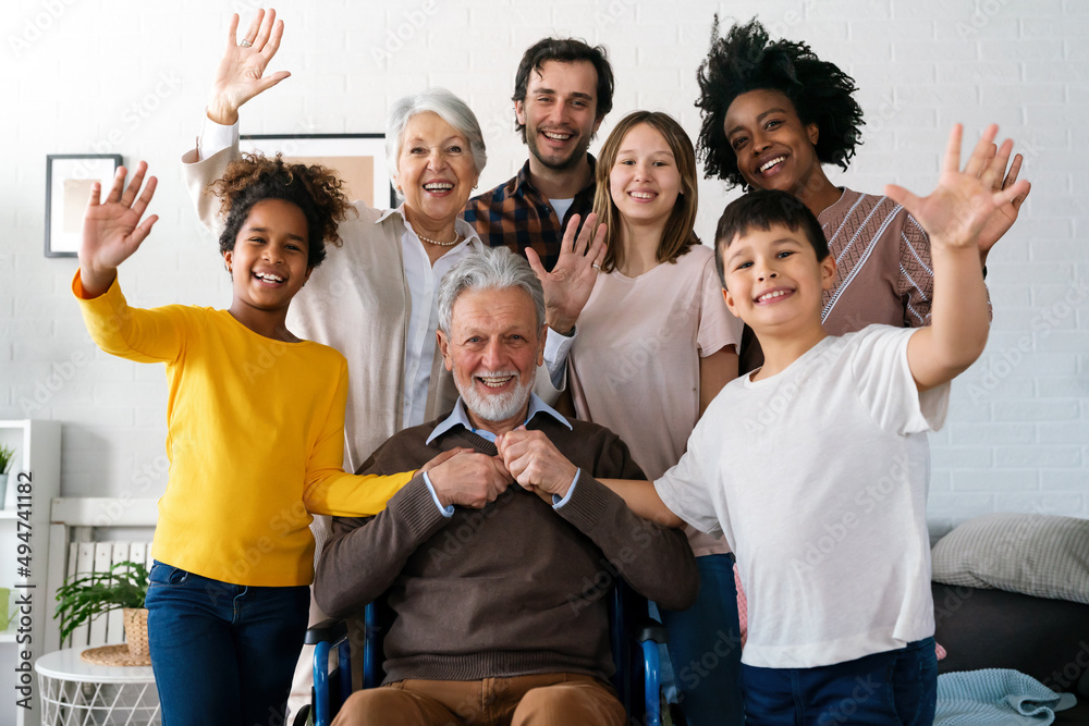 Multi generation, multiethnic family at home together, grandfather with ...