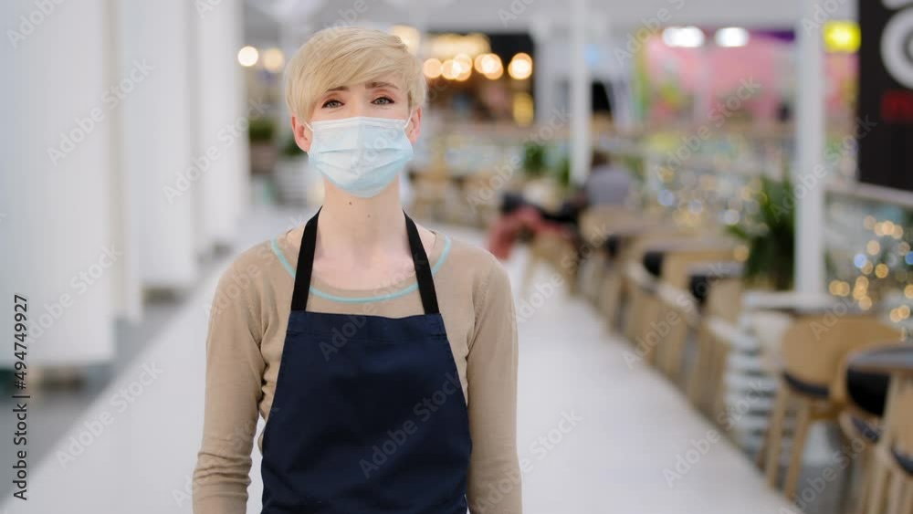 Friendly caucasian masked woman female waitress in medical face ...