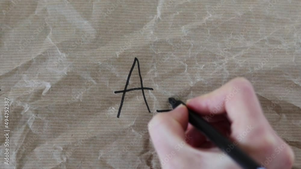 Human handwriting Greek letters alpha and omega on a crumpled paper ...