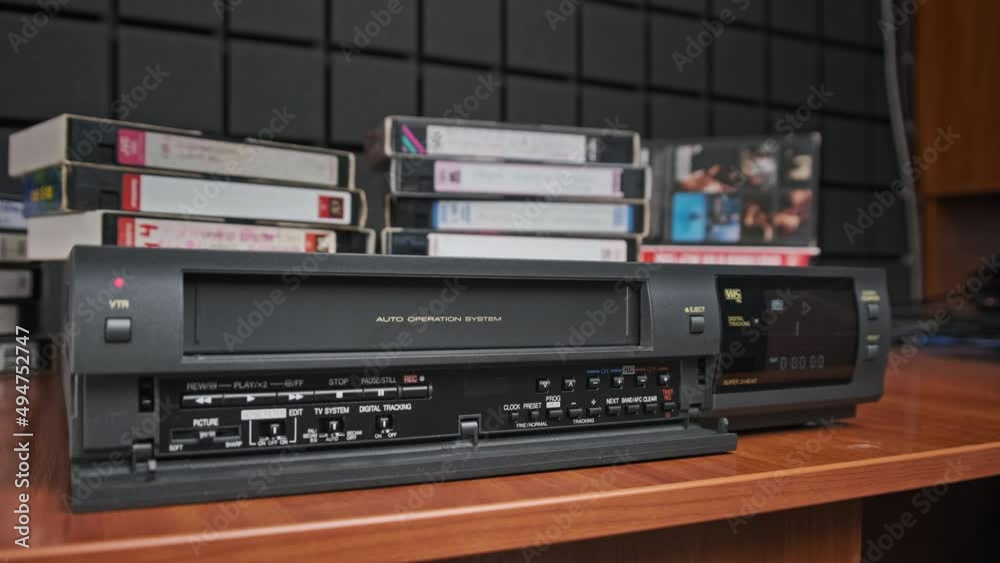 Vídeo do Stock: Insert VHS cassette into VCR and push play button ...