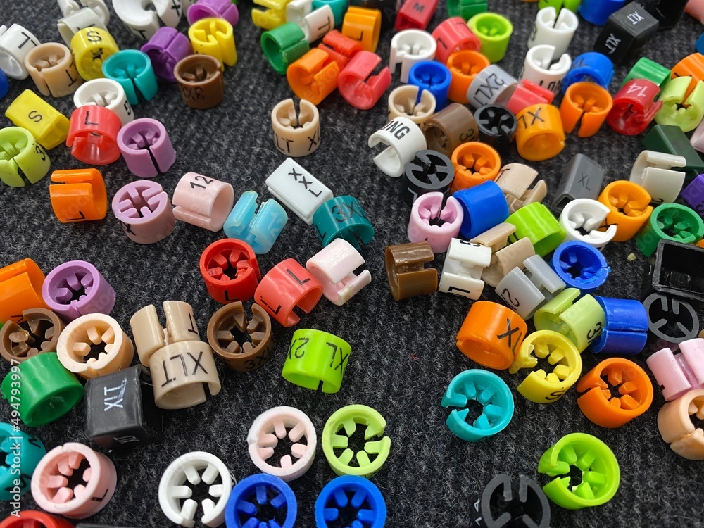 Plastic tags of clothing sizes for the store. Plastic size labels for ...