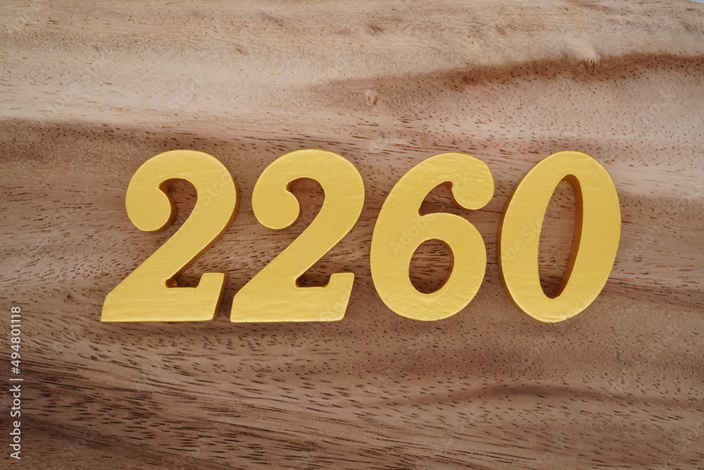 Golden Arabic numerals on a real brown and white wooden floor number ...