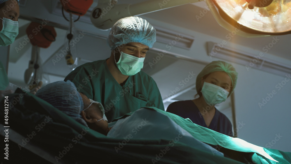 Futuristic operating room simulation - a surgeon diagnosing a senior ...