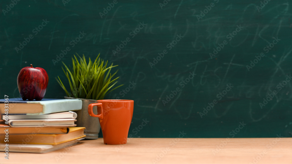 Classroom study table with copy space against green chalkboard ...