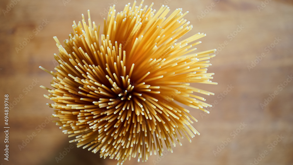 Yellow long spaghetti on a rustic background. Yellow italian pasta ...