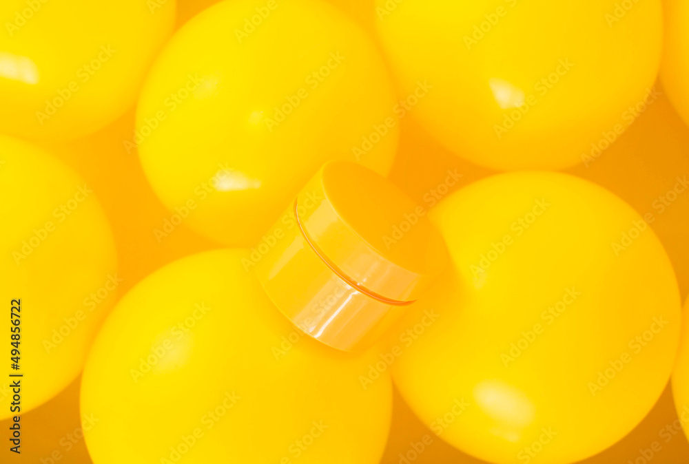 Hand cream close-up. Yellow tube on a bright yellow background Take ...