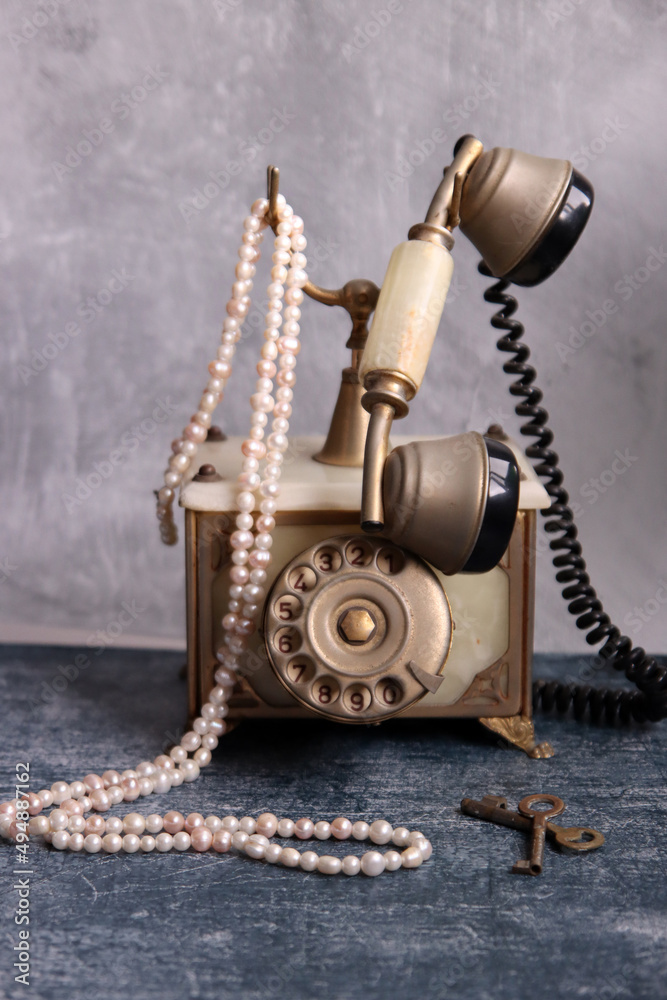 Old fashioned rotary phone on a table. Vintage telephone close up photo ...