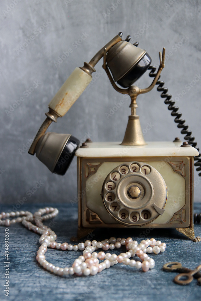 Old fashioned rotary phone on a table. Vintage telephone close up photo ...