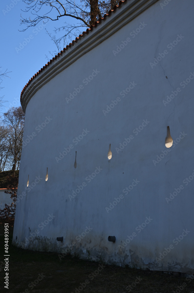 defensive wall of the castle with loopholes. zigzagging white wall with ...