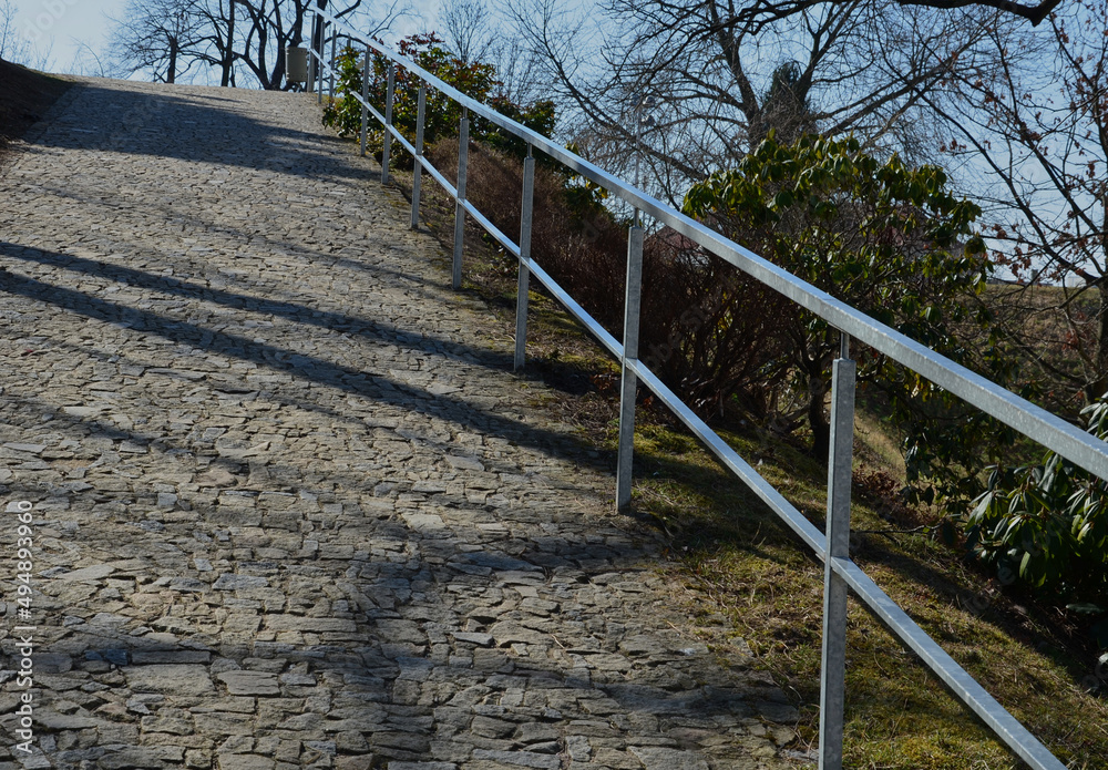 Ramp with stone paving surface. railing with galvanized surface. park ...