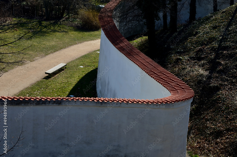 defensive wall of the castle with loopholes. zigzagging white wall with ...