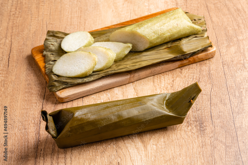 Lontong is an Indonesian dish. Rice is rolled inside a banana leaf and ...