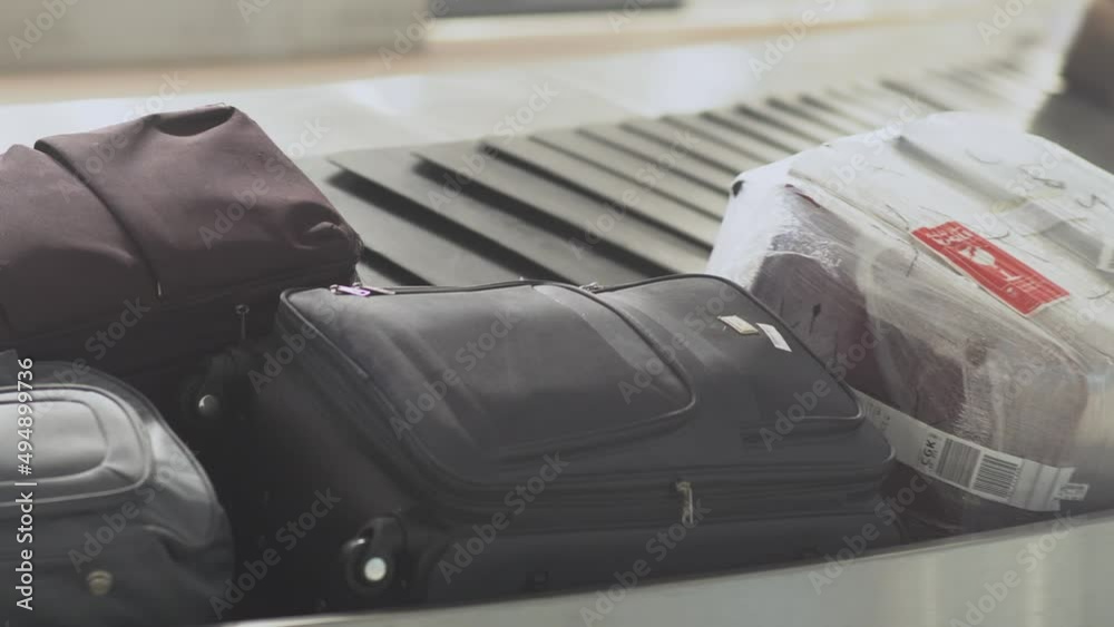 Moving luggage in the airport in the Asia. Moving luggage from left to ...