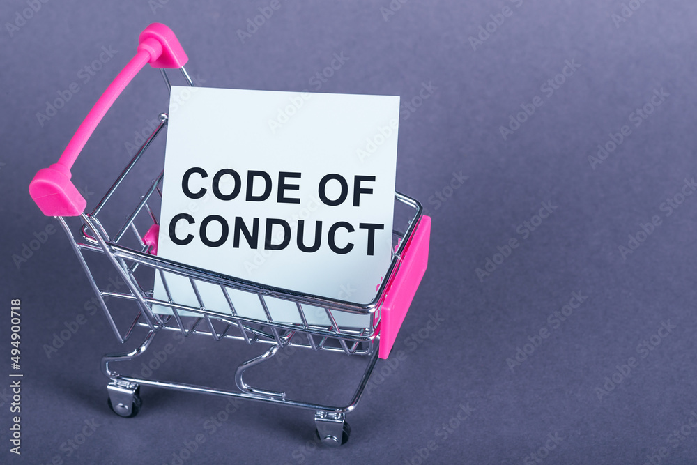 Top view of shopping cart and white card in it with Code of conduct ...