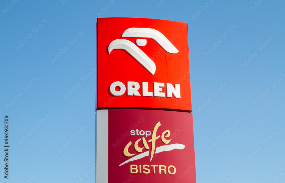 Orlen and Stop Cafe Bistro sign outside a petrol station. Logo at ...