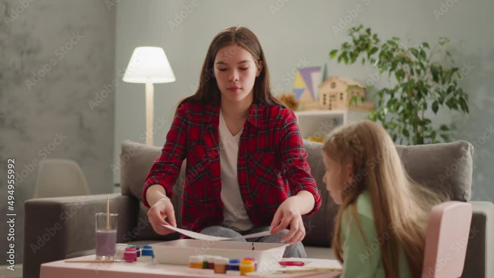 Elder sister covers tray with paint pattern with paper making Ebru art ...