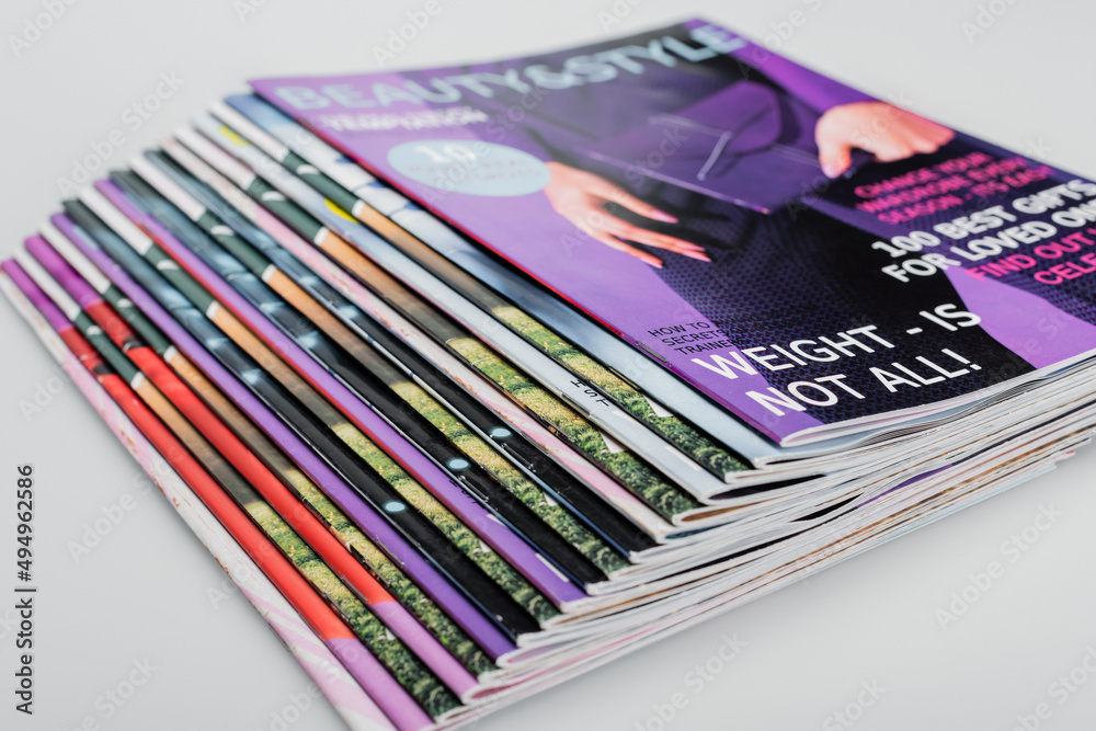 pile of beauty and style magazines on grey background, close up view ...