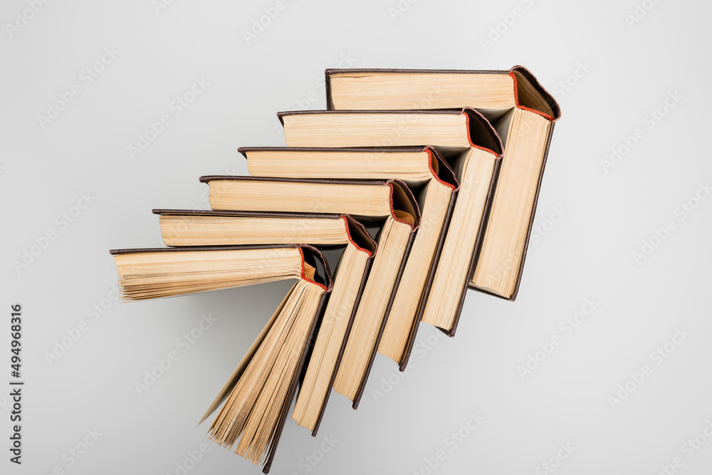 top view of open paper books on light grey background. Stock Photo ...