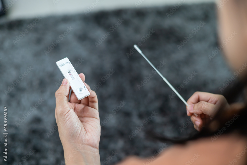 Asian woman using rapid antigen test kit for self test COVID-19 ...