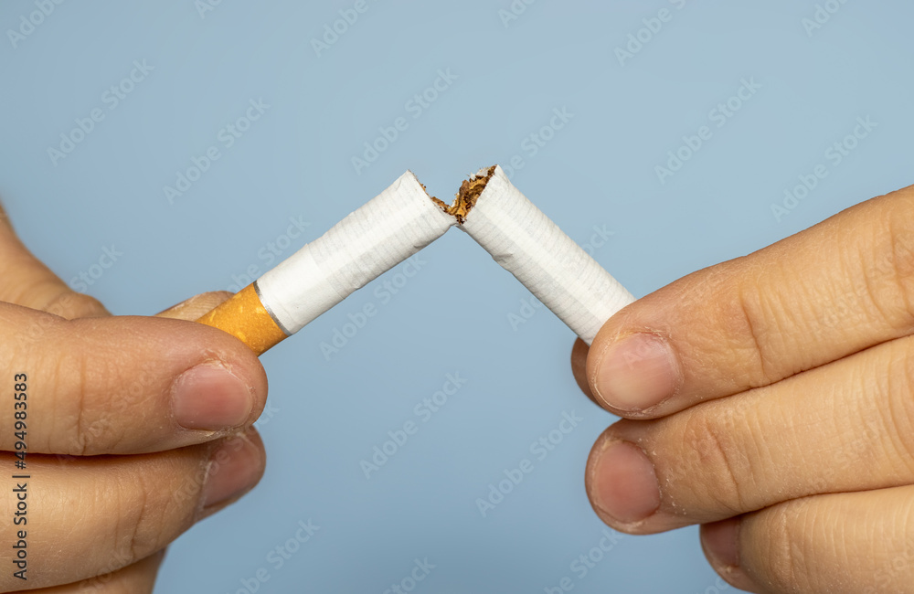 woman is crushing a cigarette. stop smoking concept. bad habits. take ...