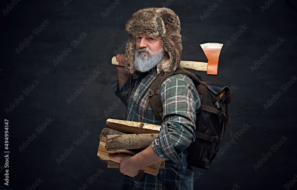 Old man woodman holding hatchet and stack of lumber Stock Photo | Adobe ...