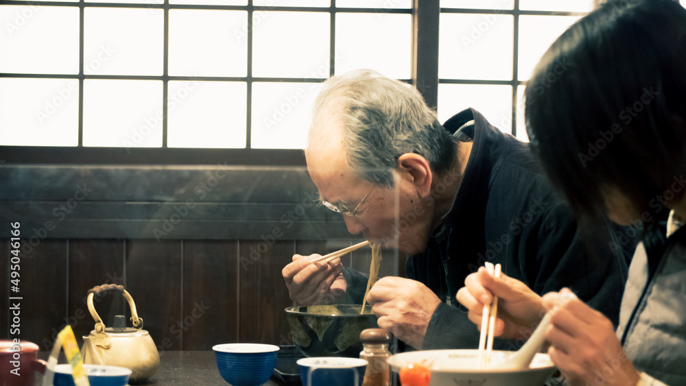 Old asian man eating ramen noodles in Japan Stock Photo | Adobe Stock