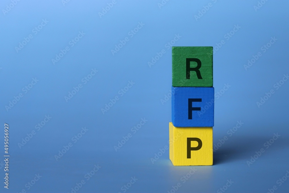 Wooden cubes with text RFP acronym for request for proposal on blue ...