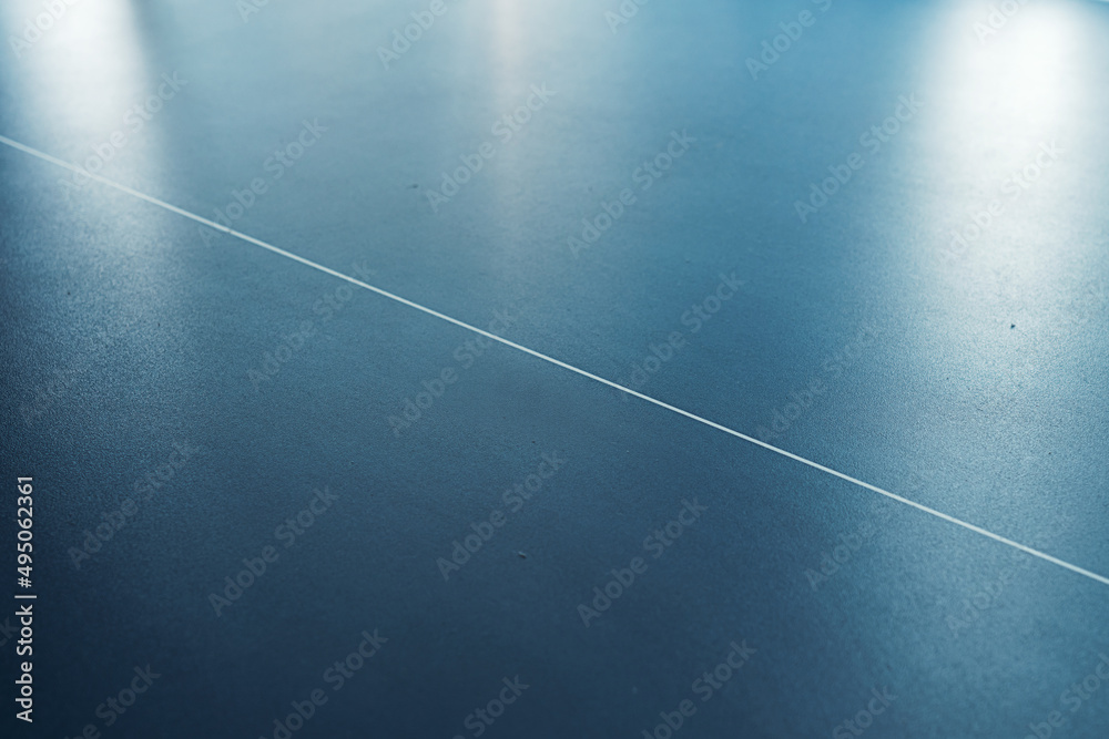 Blue colored sport playground background with white line in hall indoor ...