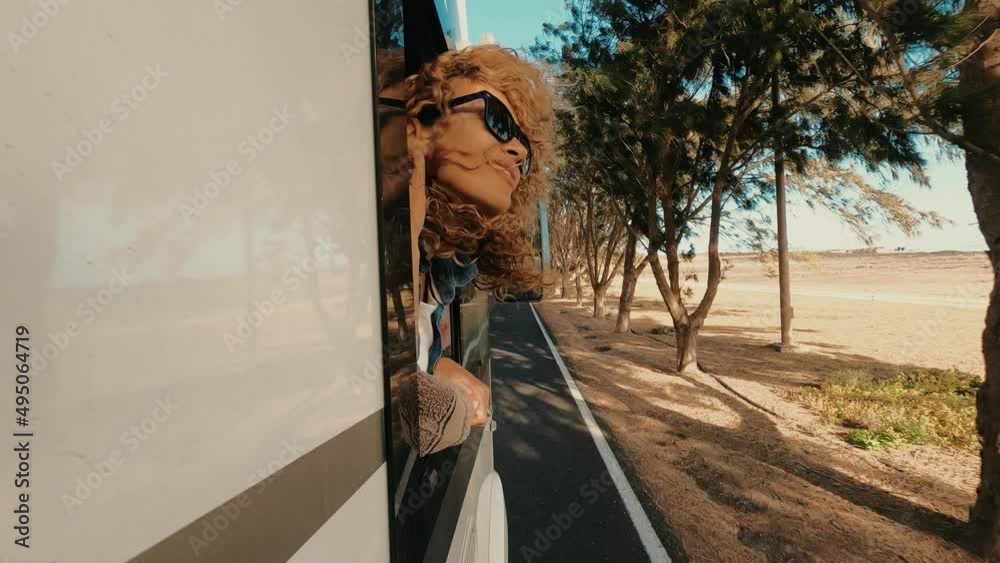 Adult traveler woman outside the window of her modern van camper ...