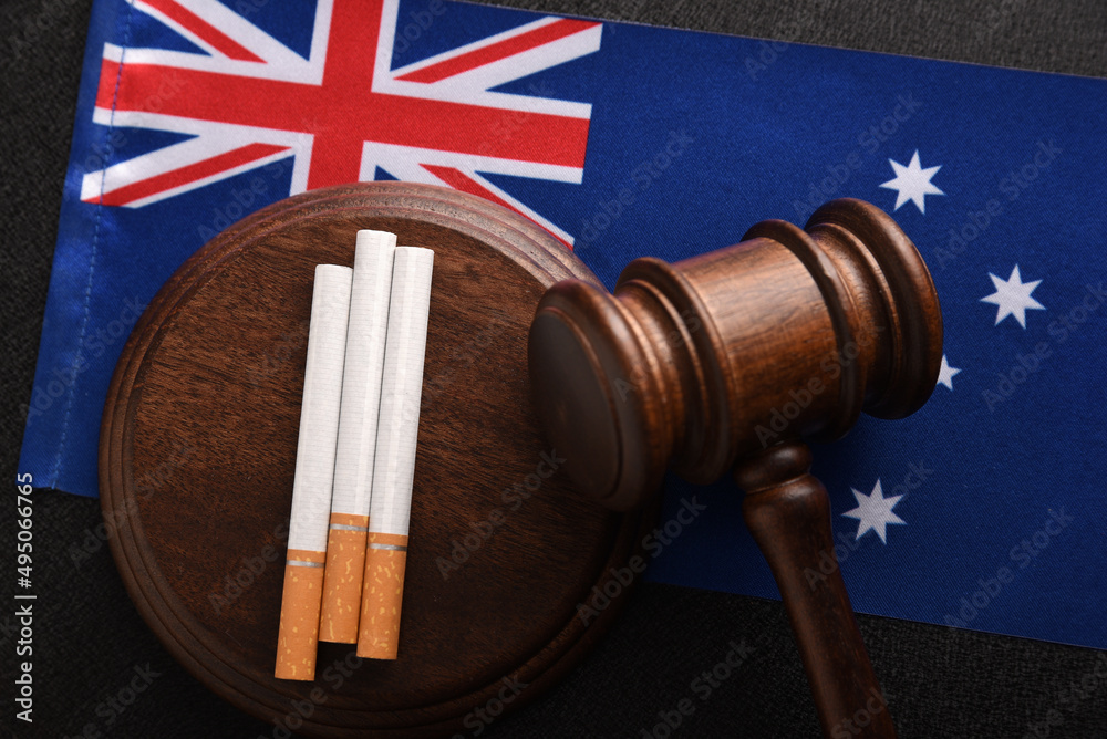 Cigarettes, wooden Judge gavel and flag of Australia. Top view. Justice ...