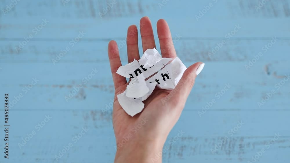 hand holding Mental health text on scrunched up piece of paper ...