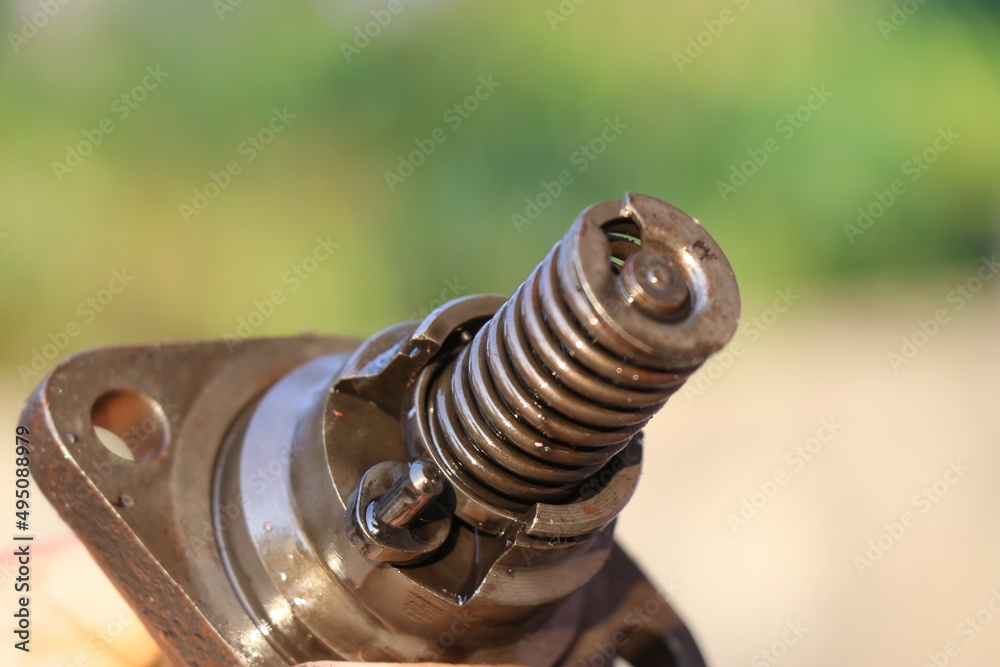 Fuel injector spring part closeup with oil all over the body, Fuel ...