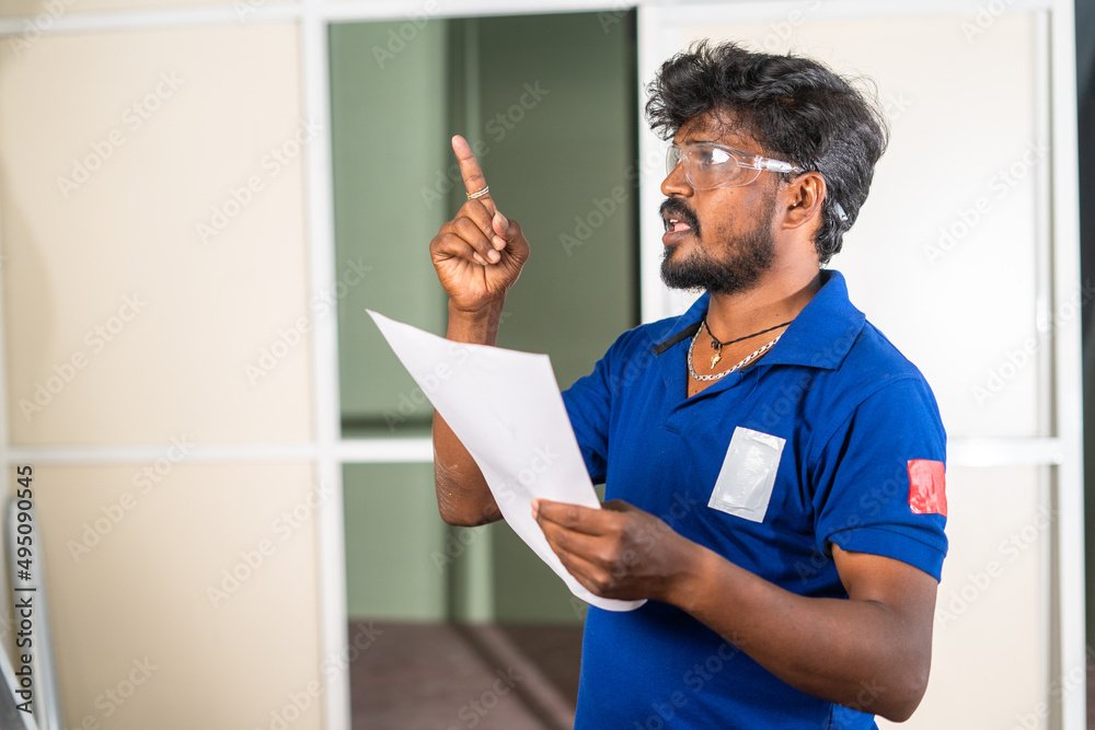 Foto de aluminium worker checking plan or list of materials required ...
