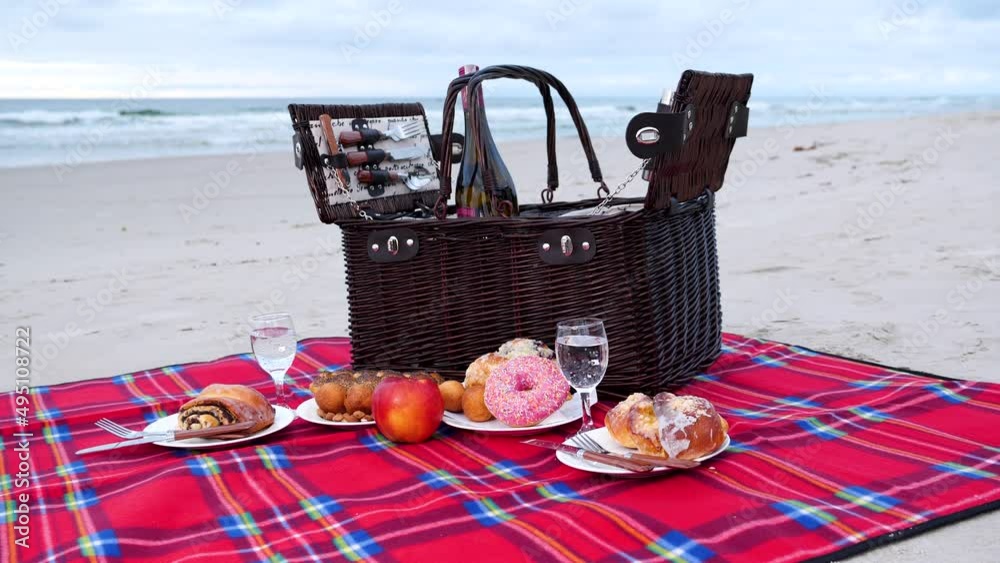 Picnic basket at the beach. Cozy and classy picnic on the sand by the ...