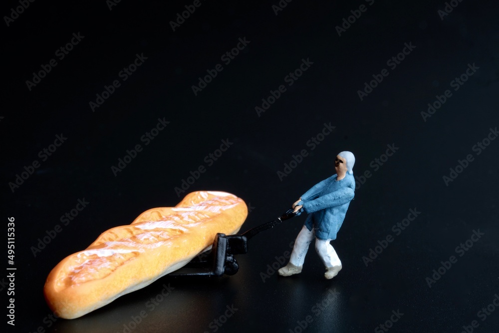 miniature figurine of a man delivering a loaf of bread Stock Photo ...