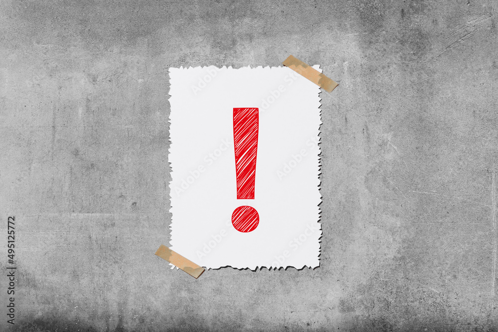 Note paper with exclamation mark on textured concrete wall background ...