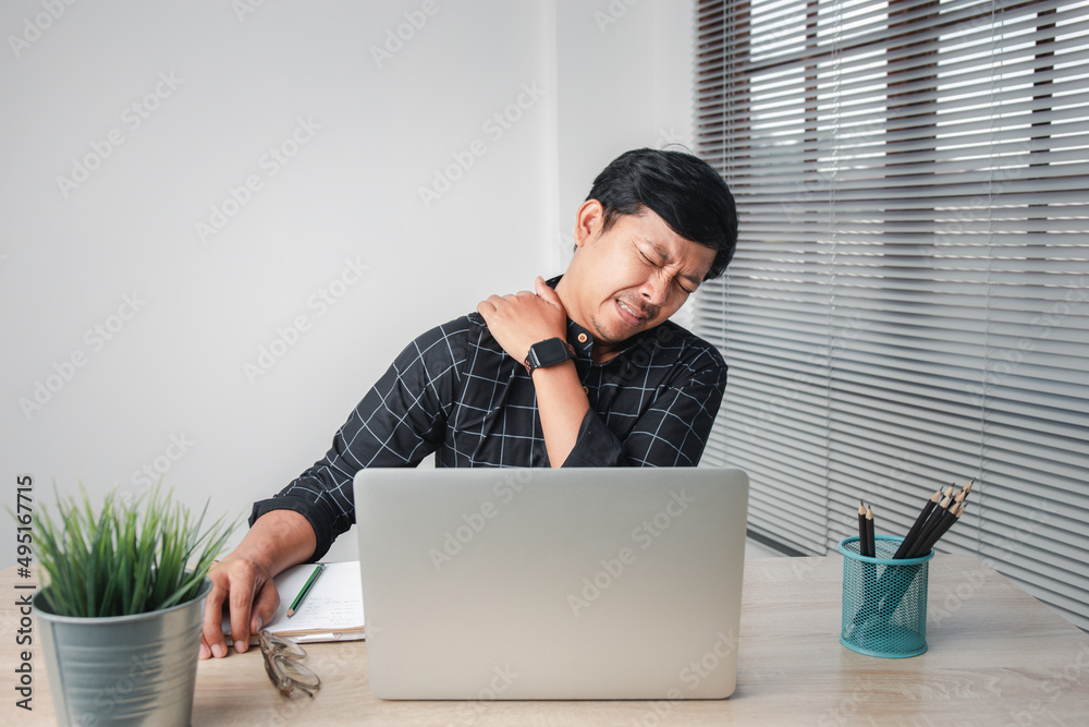 Asian business men are suffering from work-related pain from office ...