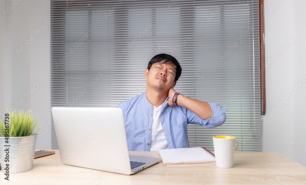 businessman is tired from working on his desk , feeling eyestrain ...
