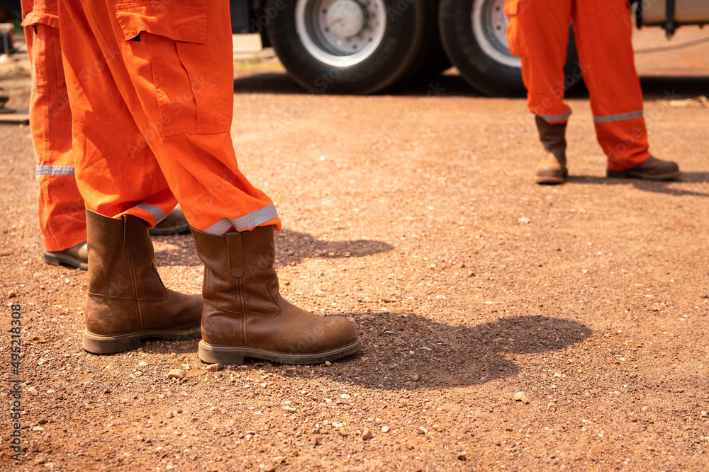 Foto de An industrial worker with Safety shoe and coverall PPE are ...