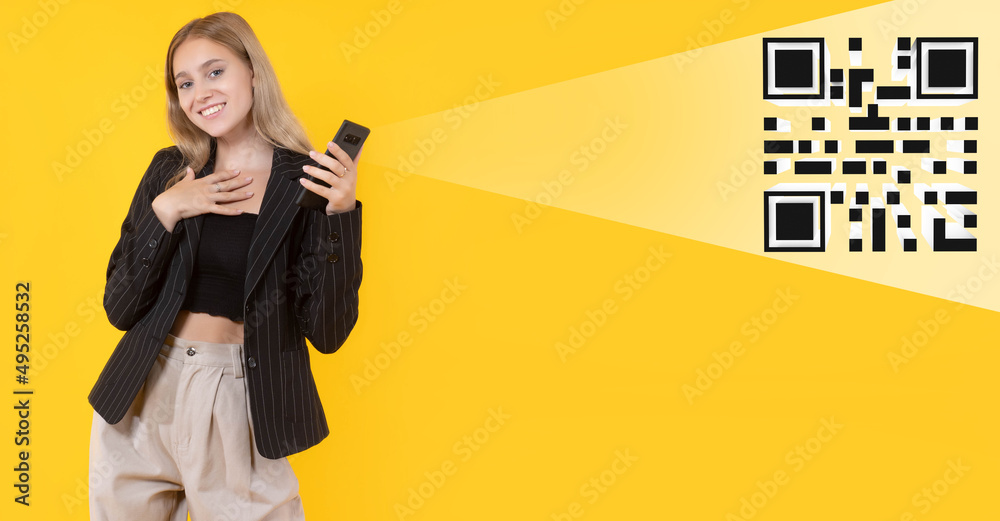 QR code scanning. A girl with a smartphone with a code reader program ...