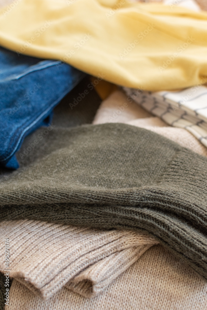 Concept of slow fashion. A mountain of clothes as a symbol of excessive ...