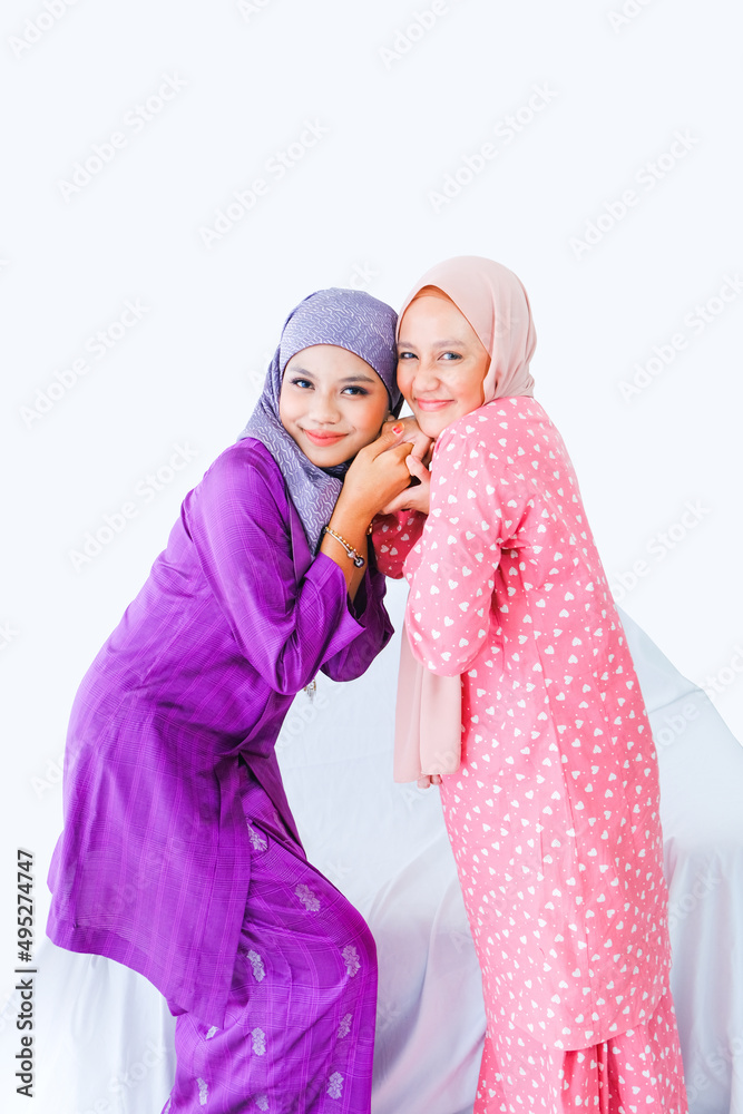 A picture of two lady shake hand each other during "Hari Raya ...